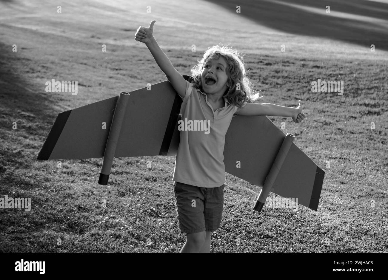 Kid superhero with jetpack. Child pilot play on summer day. Excited ...