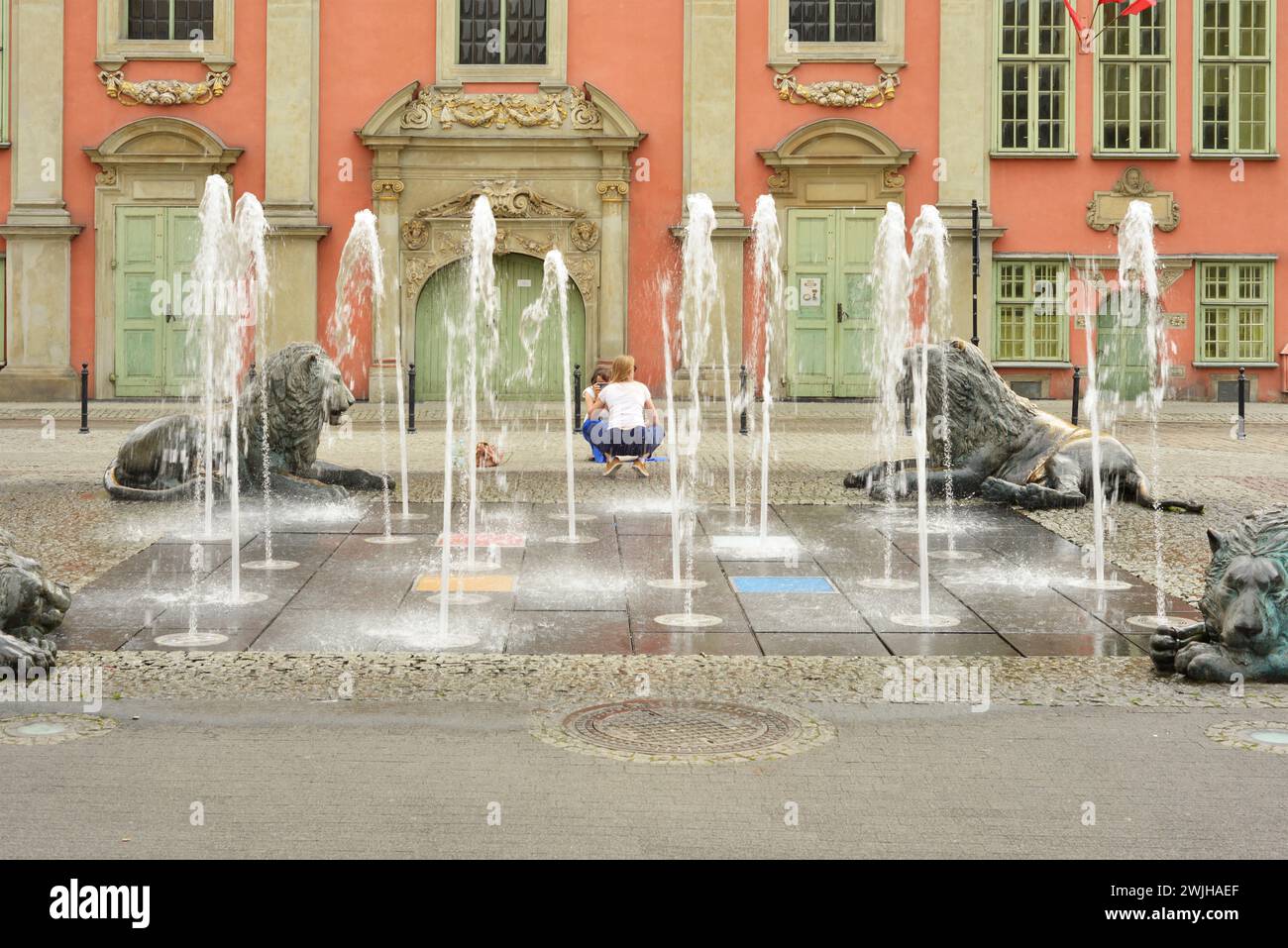Tourists taking photos at the Four Quarters Fountain or Fontanna ...