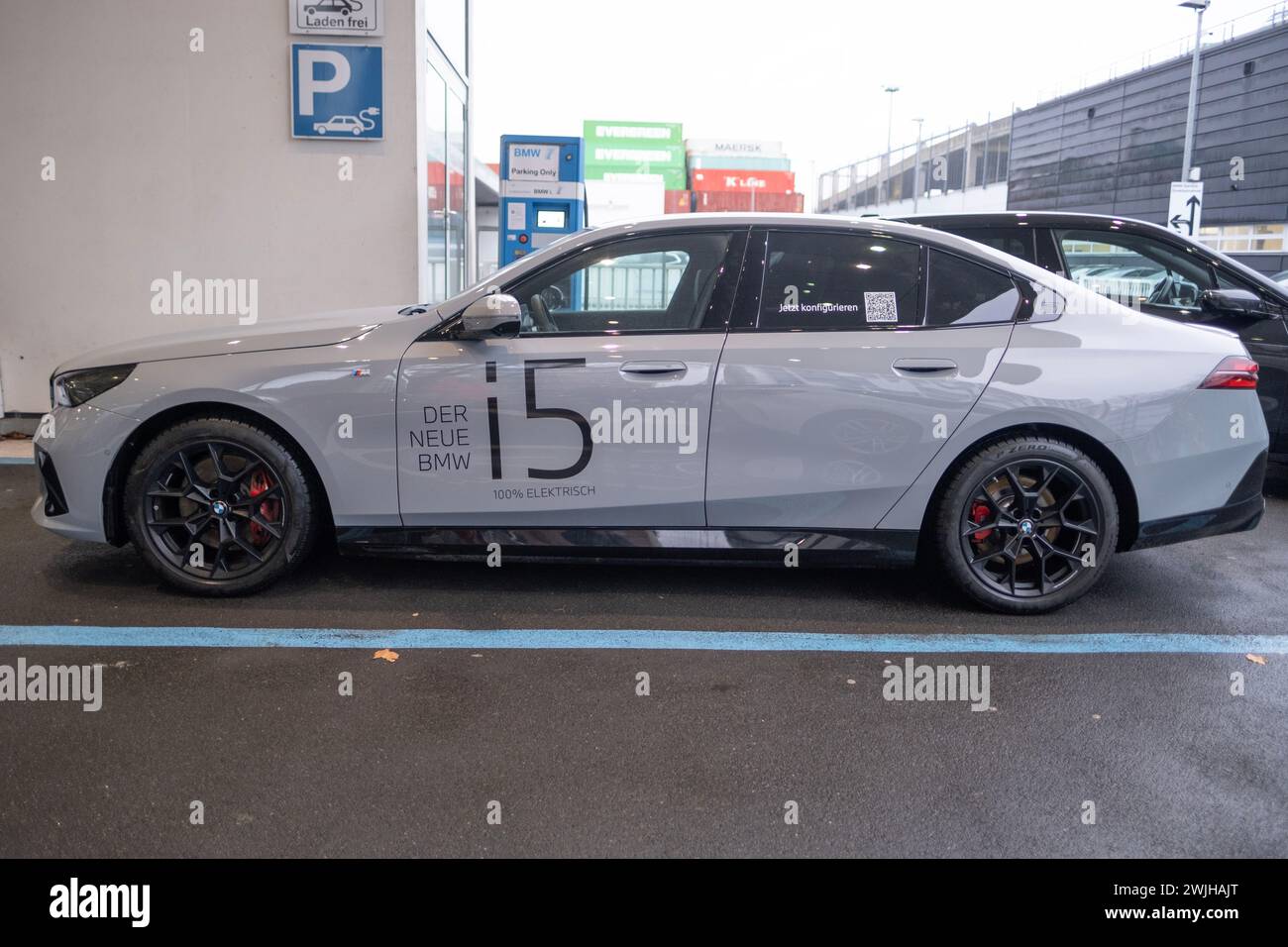 white BMW i5 eDrive40 all-electric car in parking lot, EV technological ...