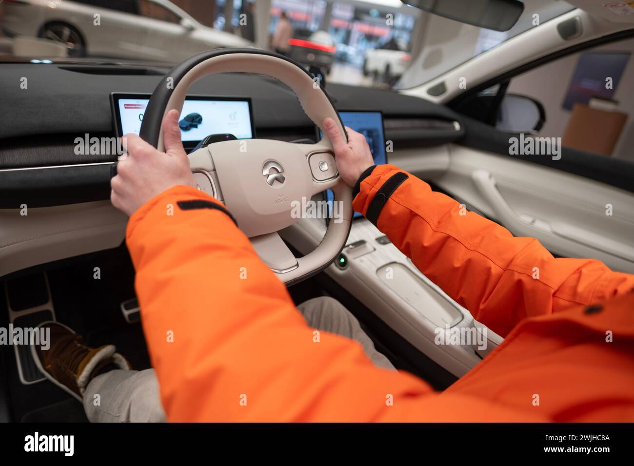 close-up male driver's hand manipulates on electronic display, steering ...