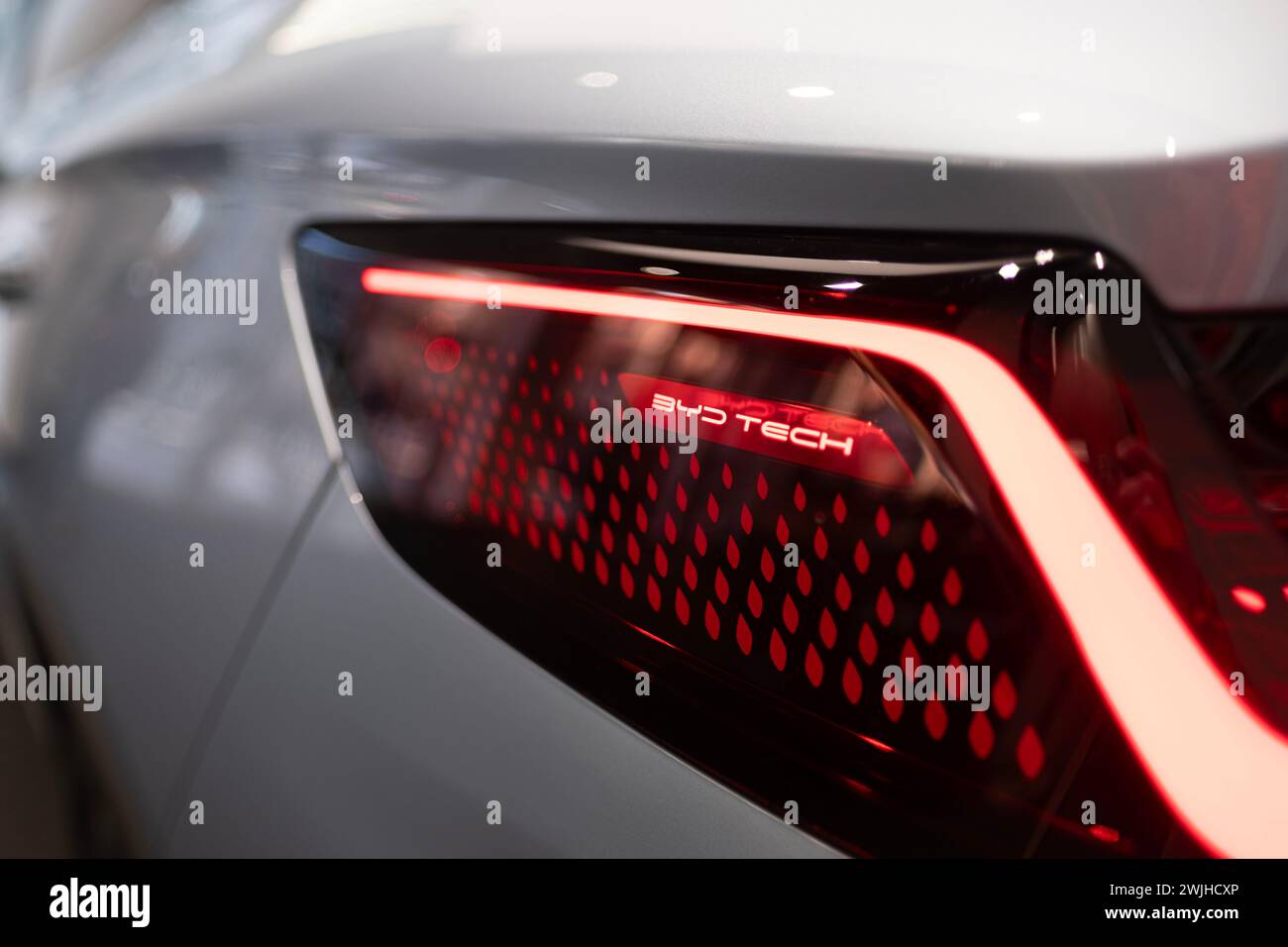 close-up glowing logotype BYD on red taillight, grey BYD Seal U 2024 ...