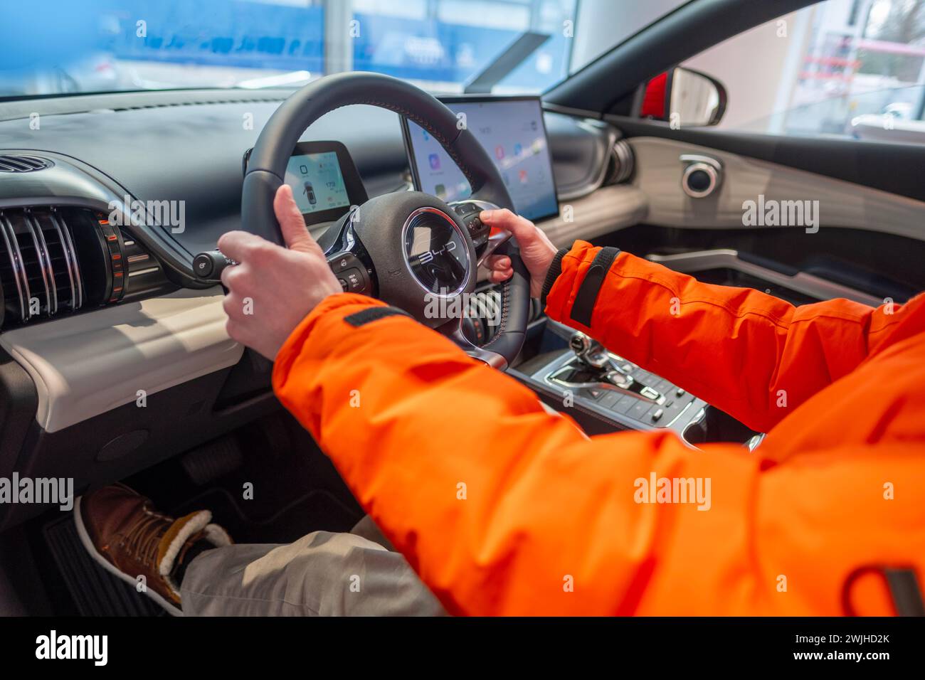 male hands on steering wheel, Interior, cockpit of BYD ATTO 3 Car in ...