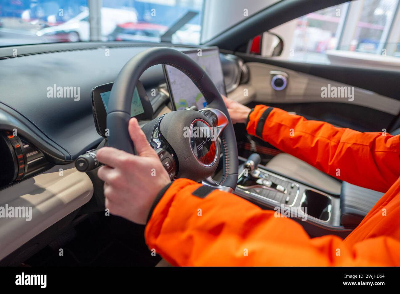 man in car driving BYD ATTO 3 Car Electric Car, male hand on button ...