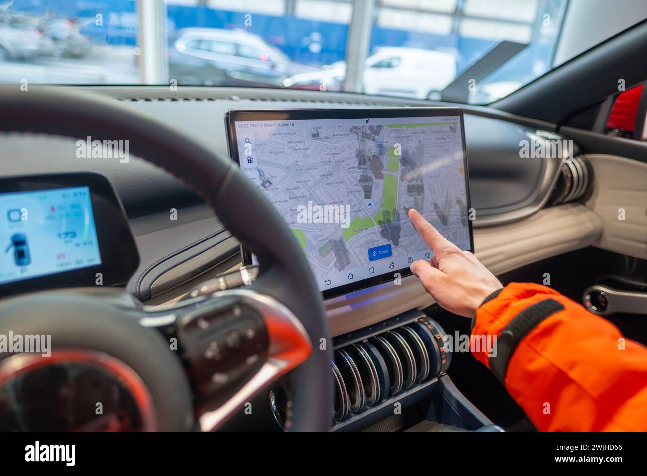 close-up male driver's hand manipulates on electronic display, steering ...