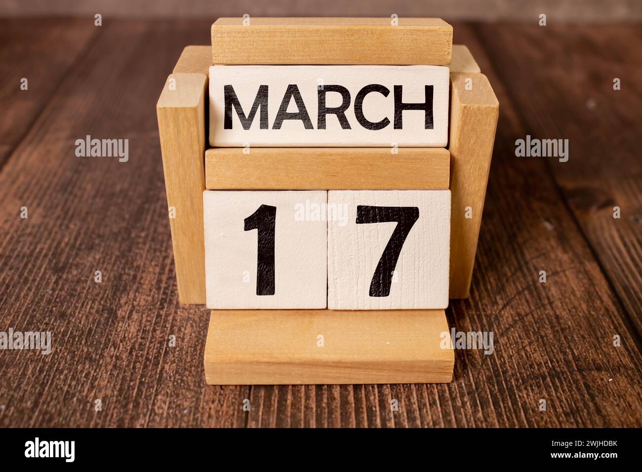 March 17 calendar date text on wooden blocks with blurred park ...