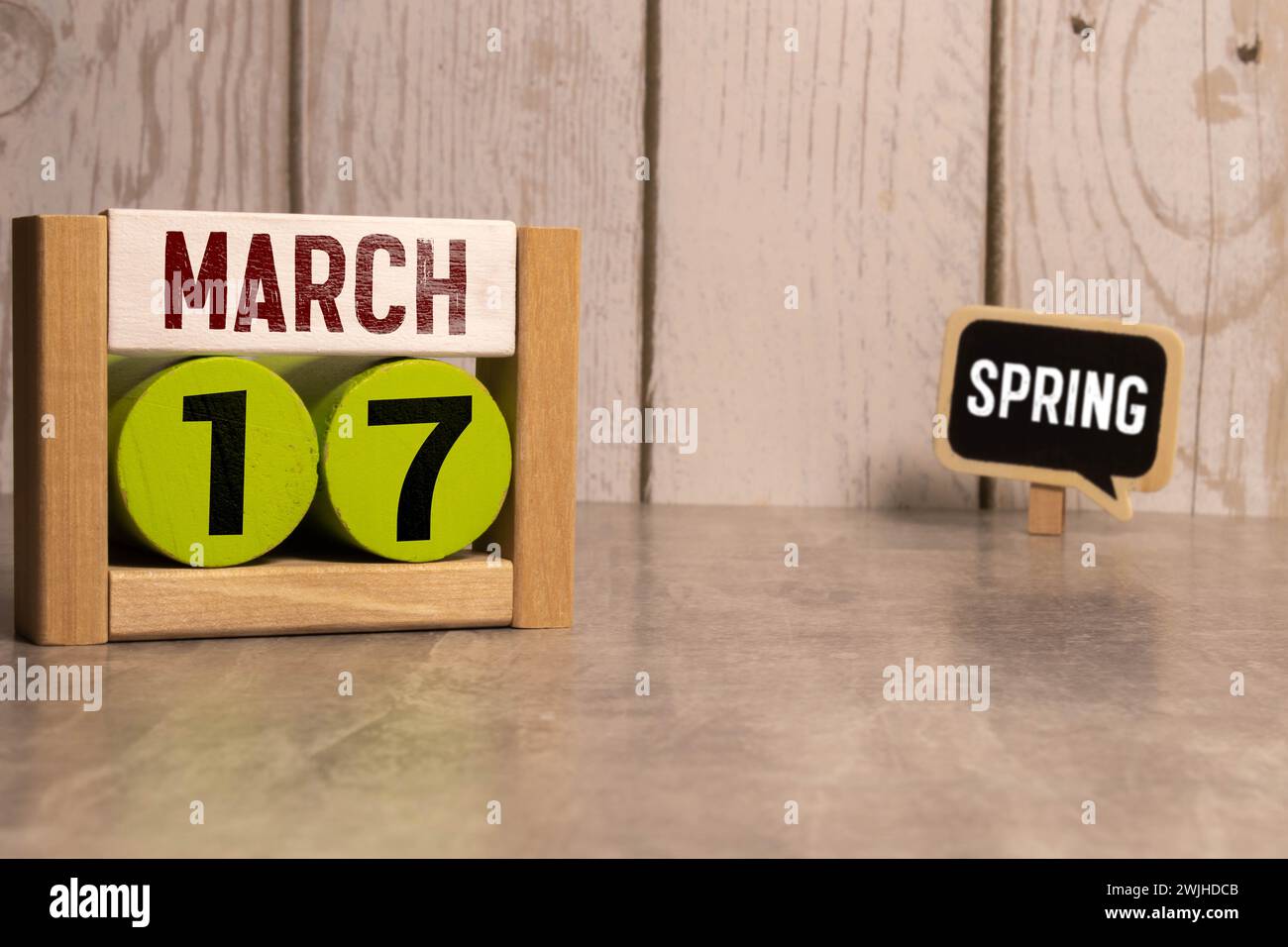 March 17 calendar date text on wooden blocks with blurred park ...