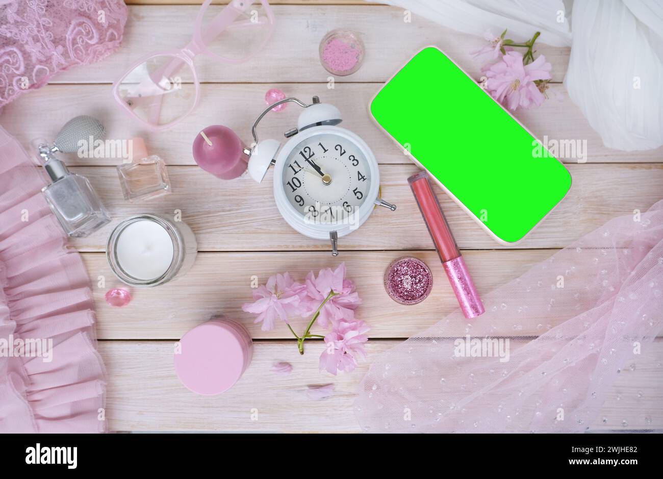 coffee cup, smartphone with blank green screen, cosmetics, perfume in ...