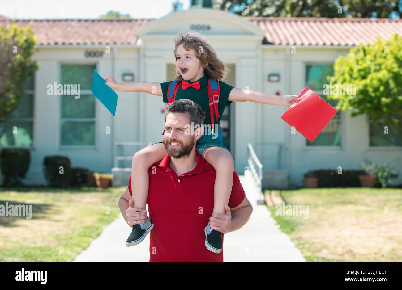 Father and son run with father after come back from school. School ...