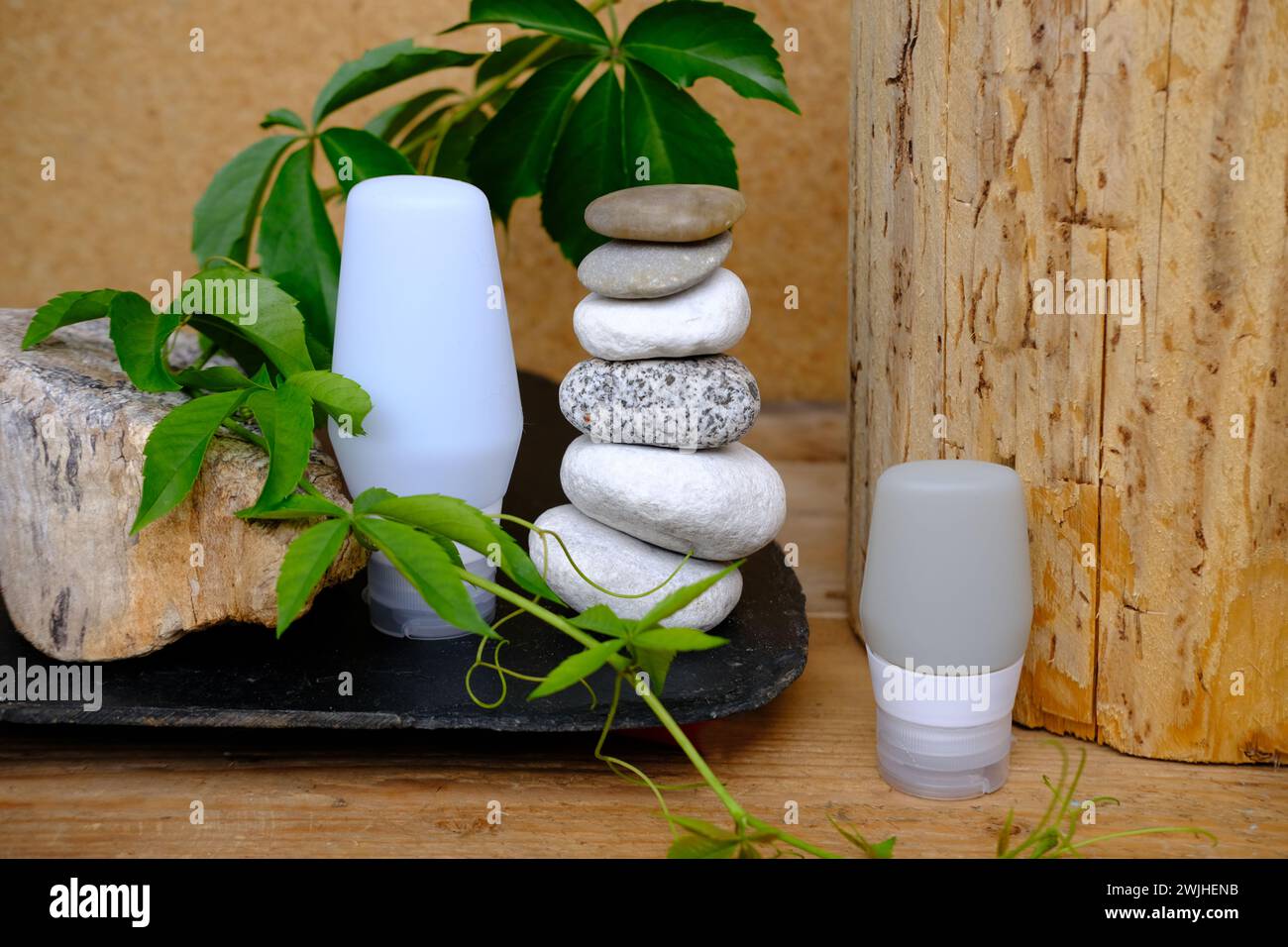 Round stones arranged in Zen tower pyramid, green plants, wooden ...
