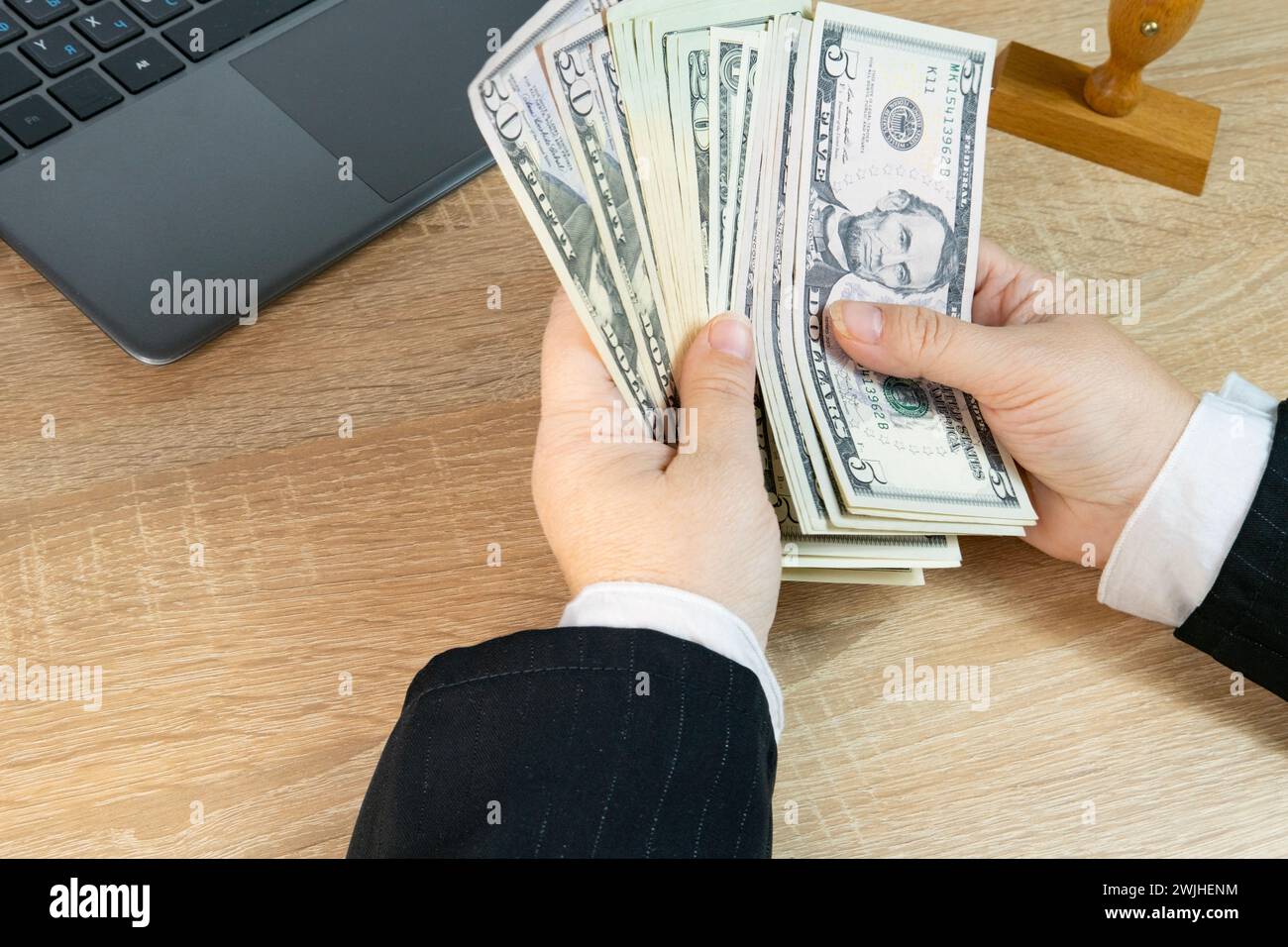 Close-up of female bank employee's hands counting dollar bills, paper ...