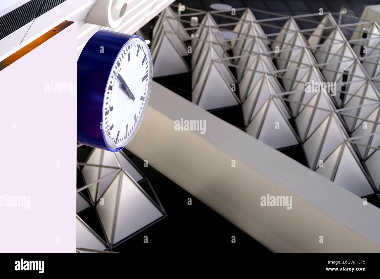 large modern clock in airport on a beautiful background, geometric ...