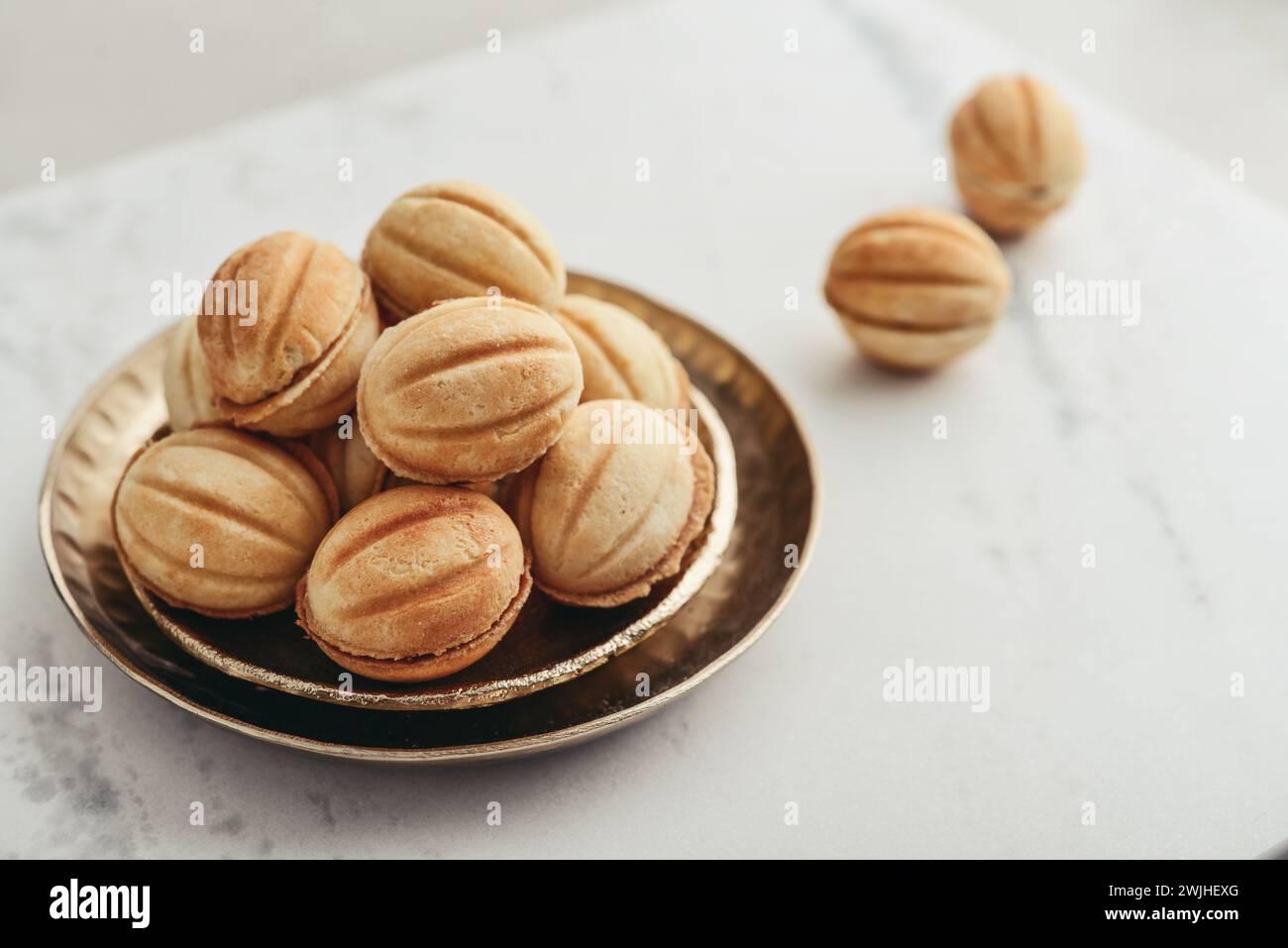 Homemade walnut shaped cookies with boiled condensed milk on white ...