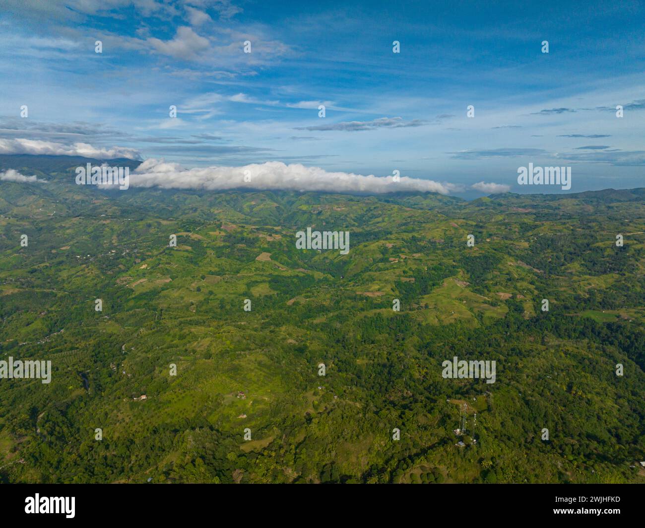 Mountain range with rainforest. Blue sky and clouds. Mindanao ...