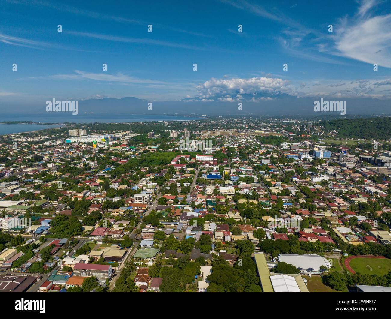Flying over the buildings and houses in Davao City. Mindanao ...