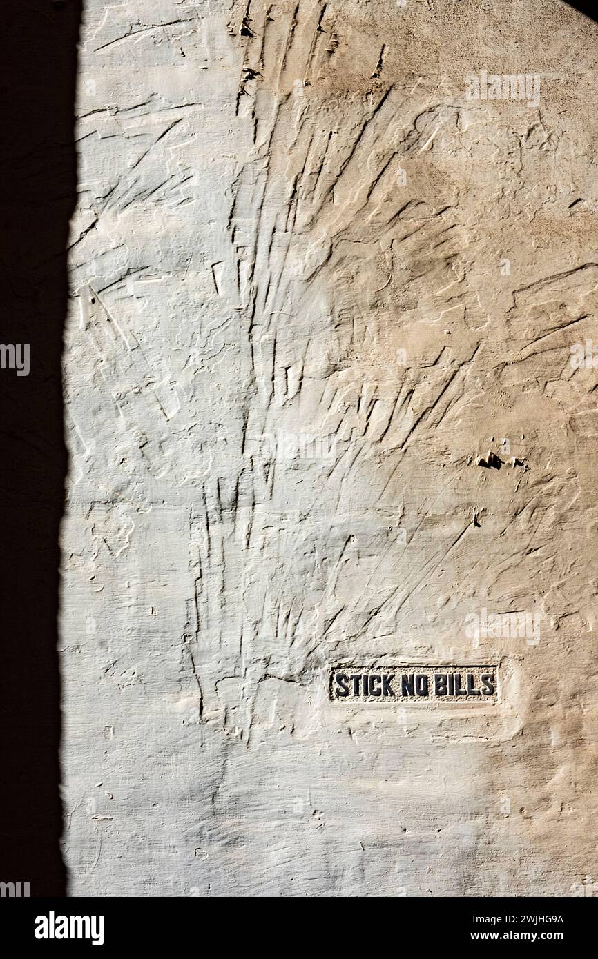 "Stick no bills," texture on a wall requesting no advertisements be ...