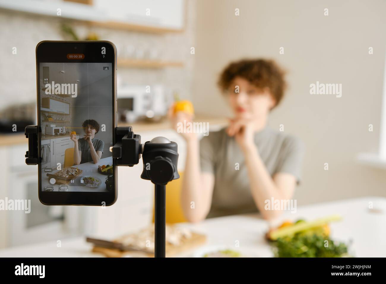 Professional nutritionist filming on her smartphone tutorial about ...