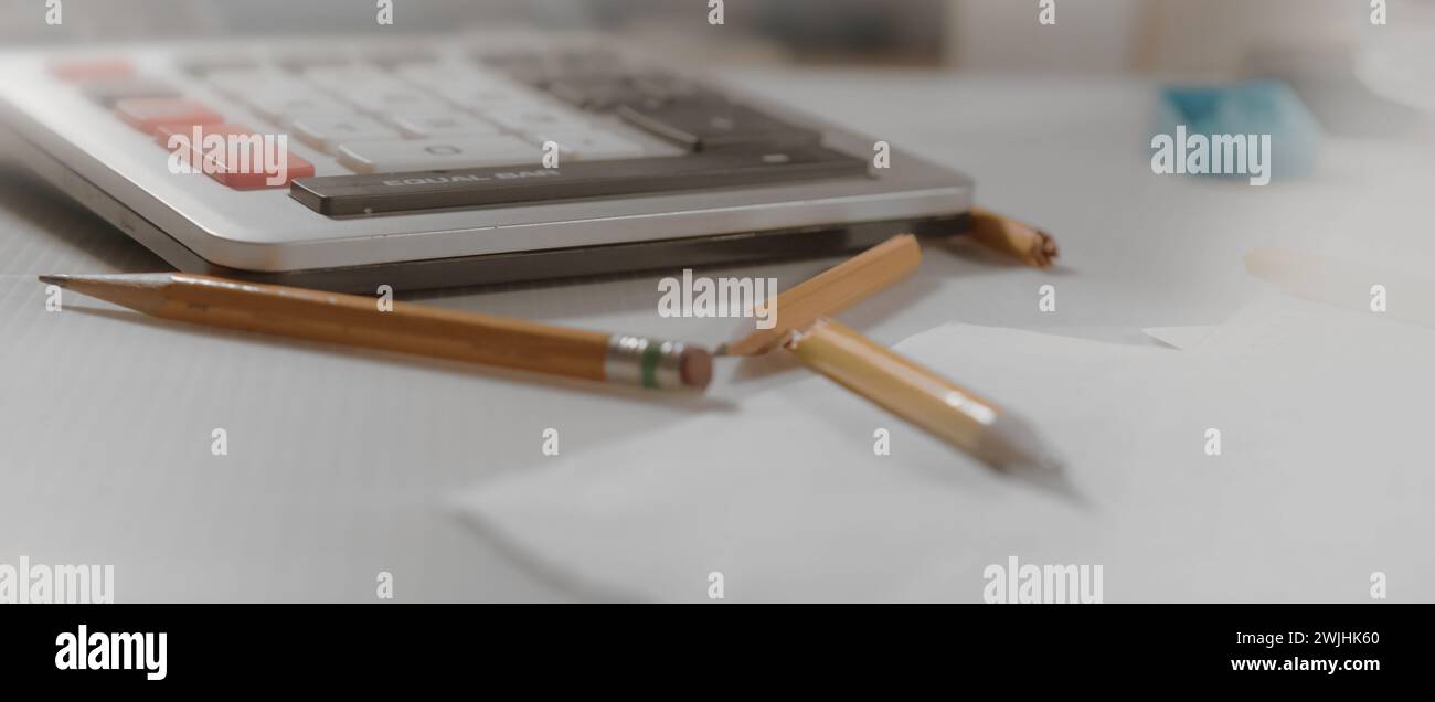 Copy-space. Calculator, broken pencils Stock Photo - Alamy