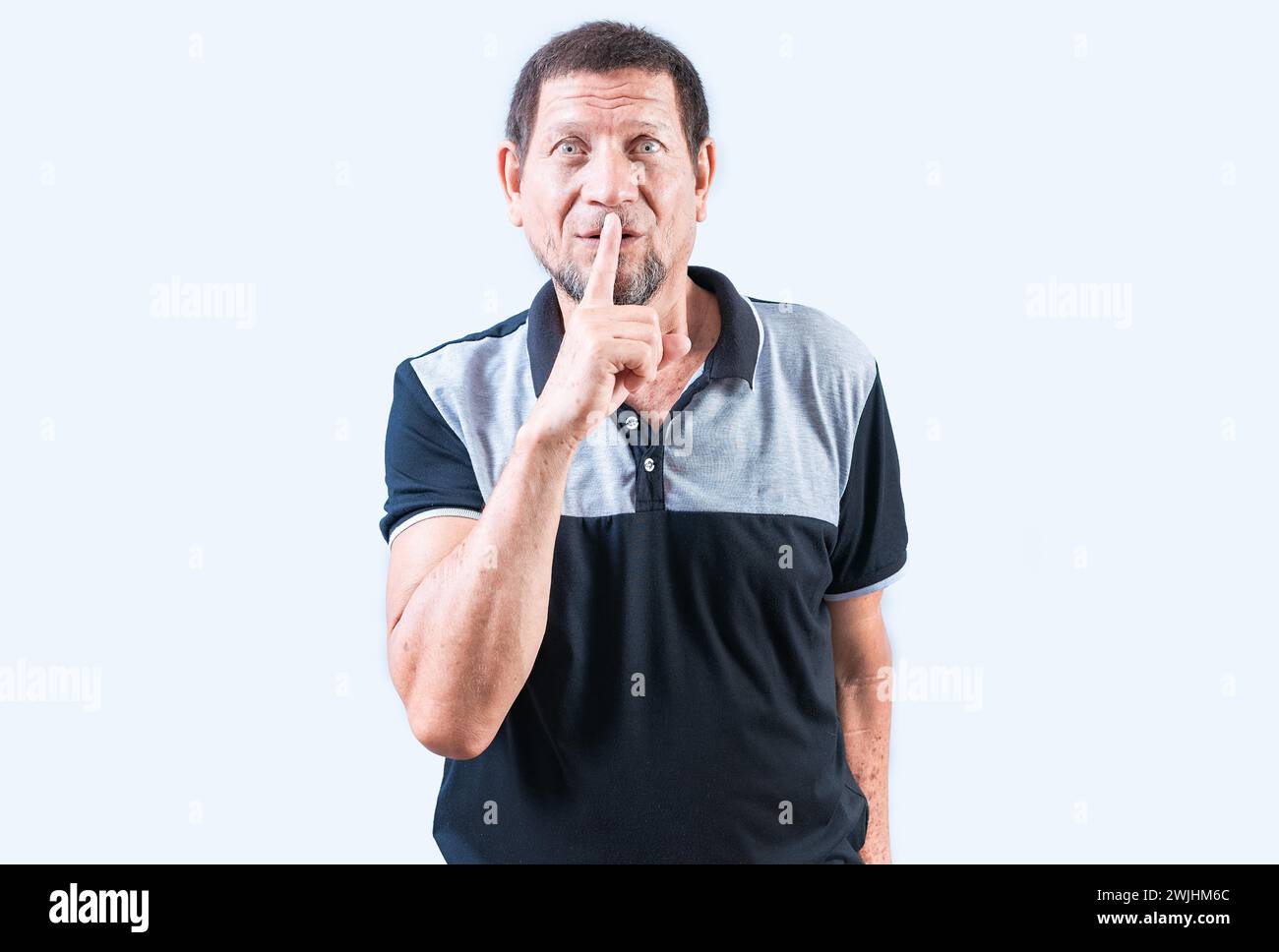 Old man making silence gesture with finger. Elderly man making silence ...