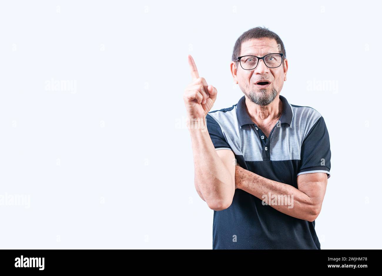 Shocked old man in glasses pointing at a advertising up. Surprised ...