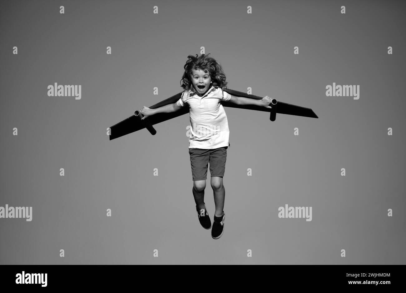 Child to be pilot. Kid with paper wings flying. Summer vacation and ...