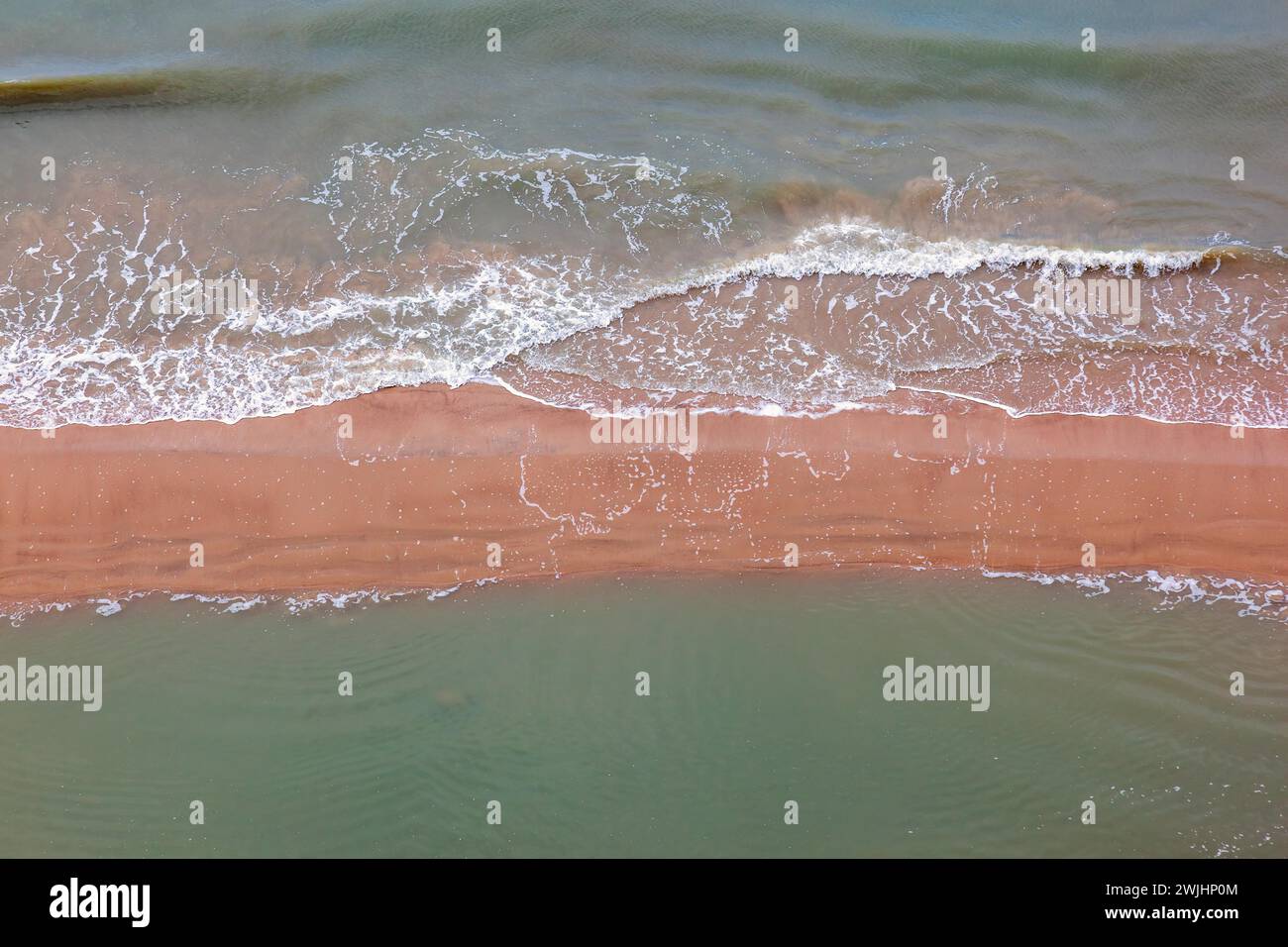 Aerial view at sea waves rolling in to a sand beach, Skagen, Denmark ...