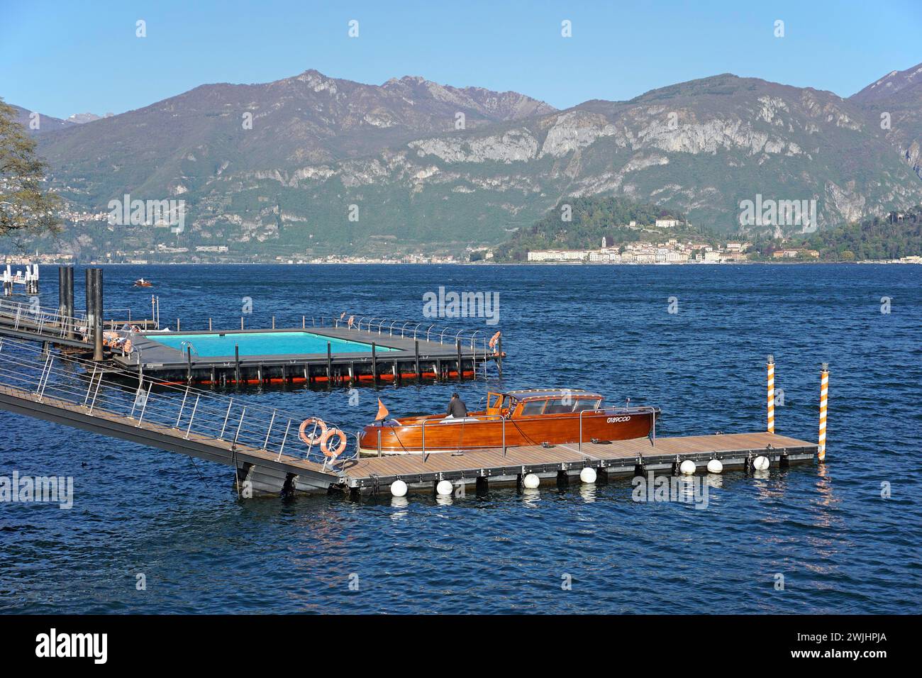 Traditional wooden boat, swimming pool in Lake Como, Grand Hotel ...