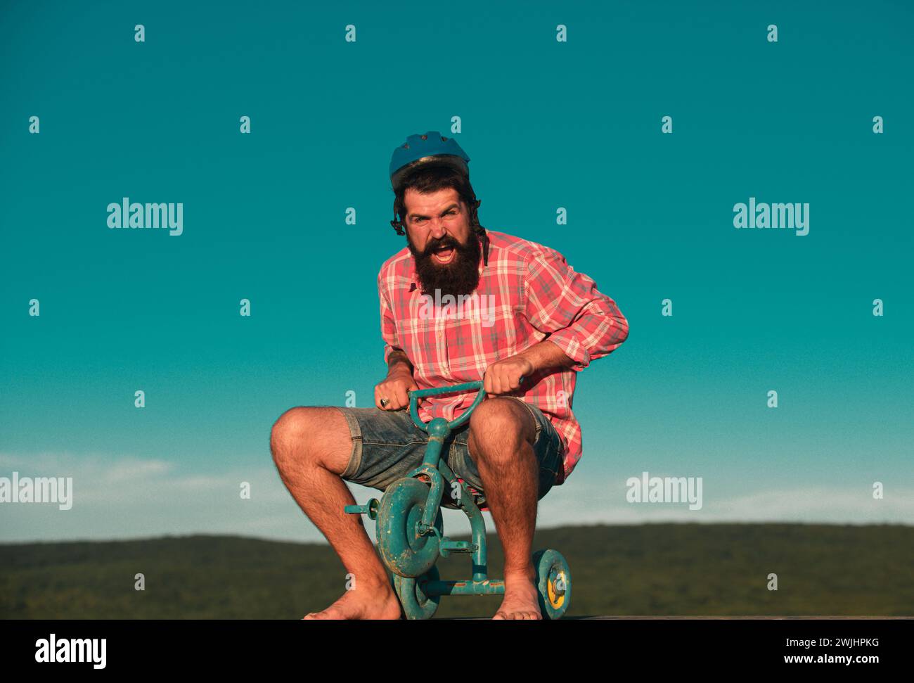Crazy young man riding a small bike hi-res stock photography and images ...
