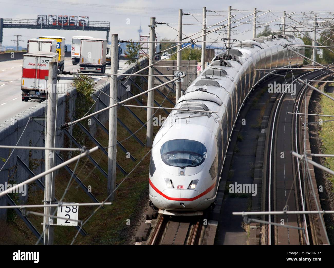 A Deutsche Bahn ICE train passes cars on the A3 motorway, Floersheim ...