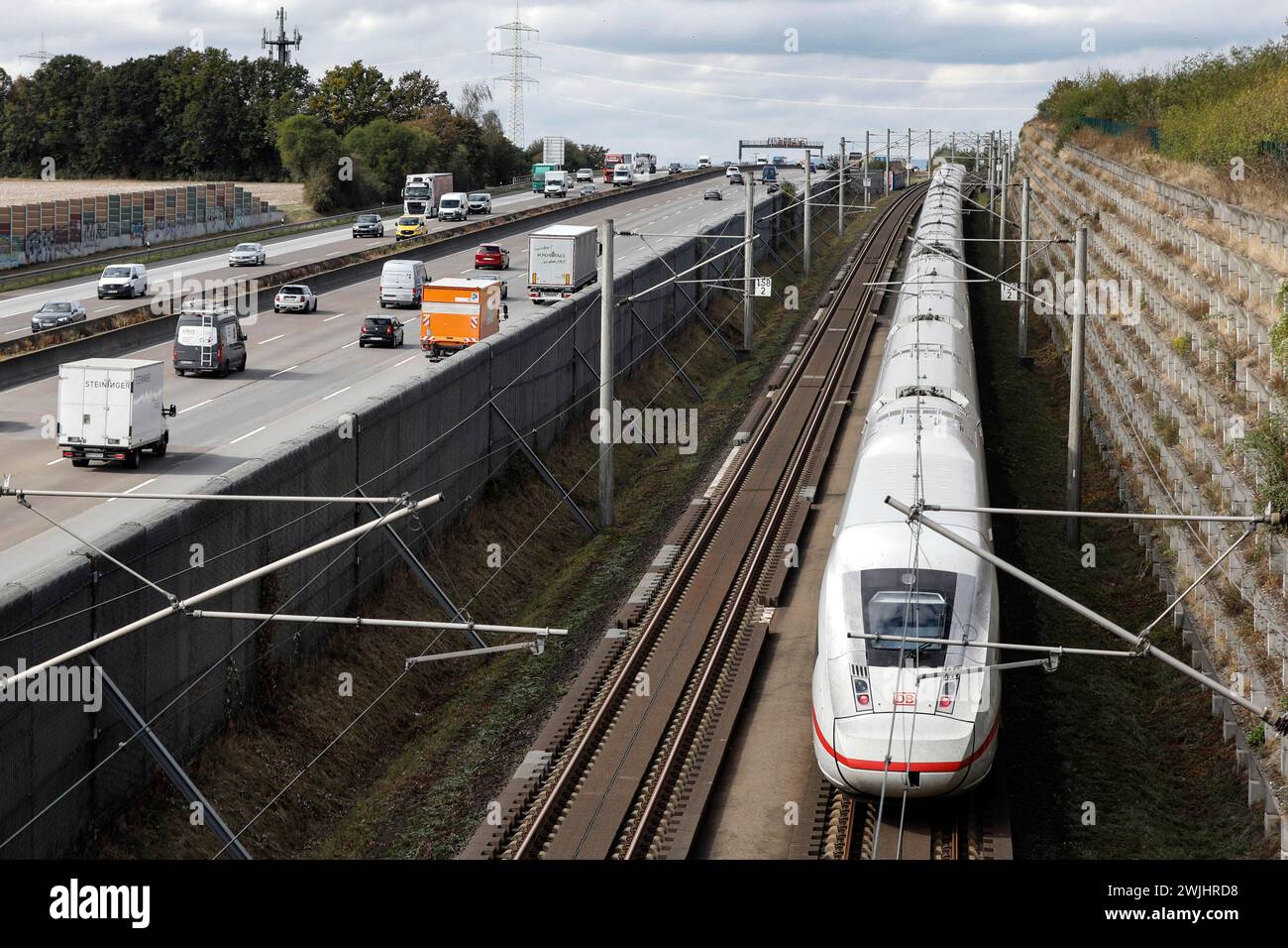 A Deutsche Bahn ICE train passes cars on the A3 motorway, Floersheim ...