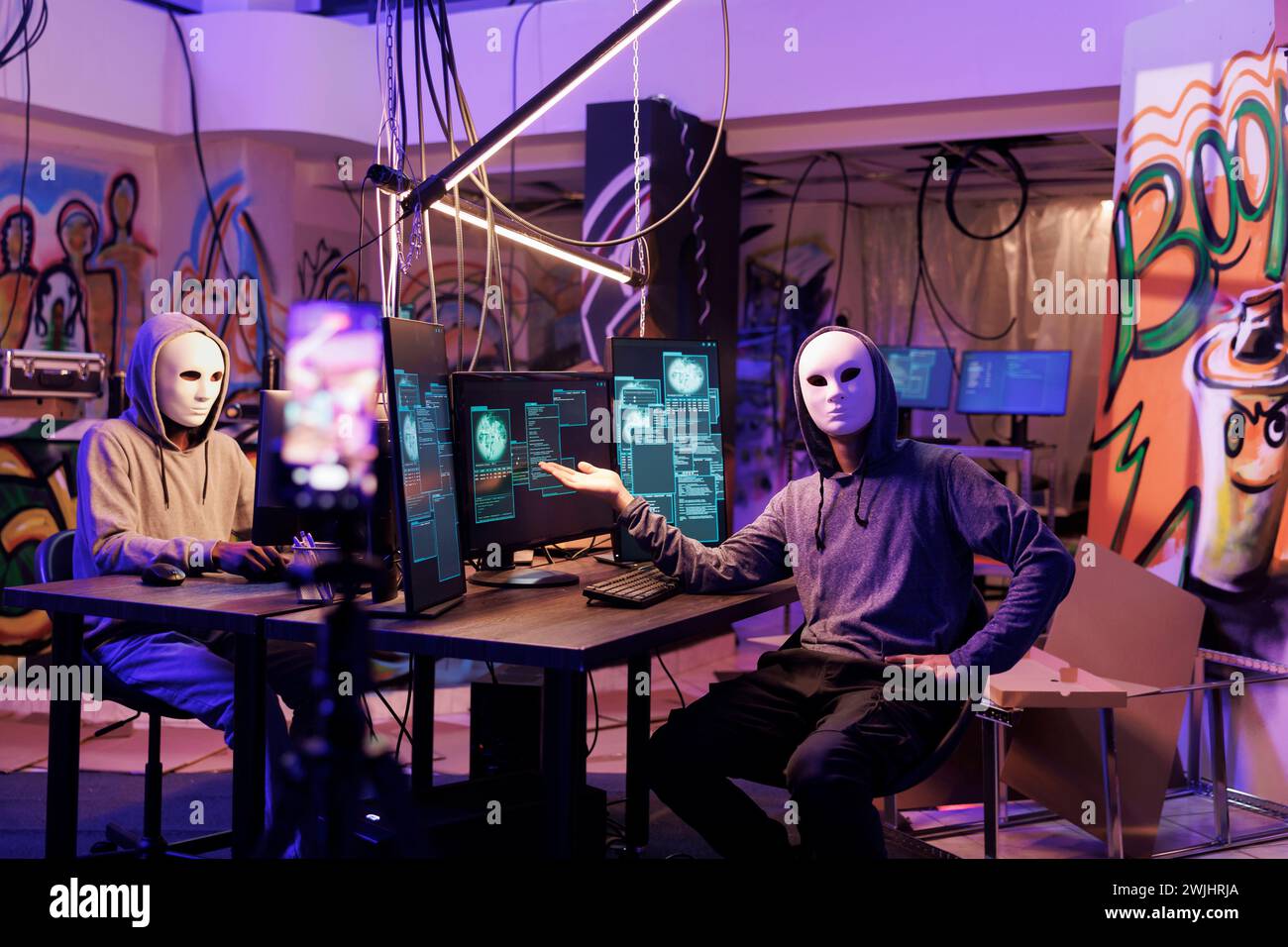 Anonymous scammers recording fraud video while planning phishing attack ...