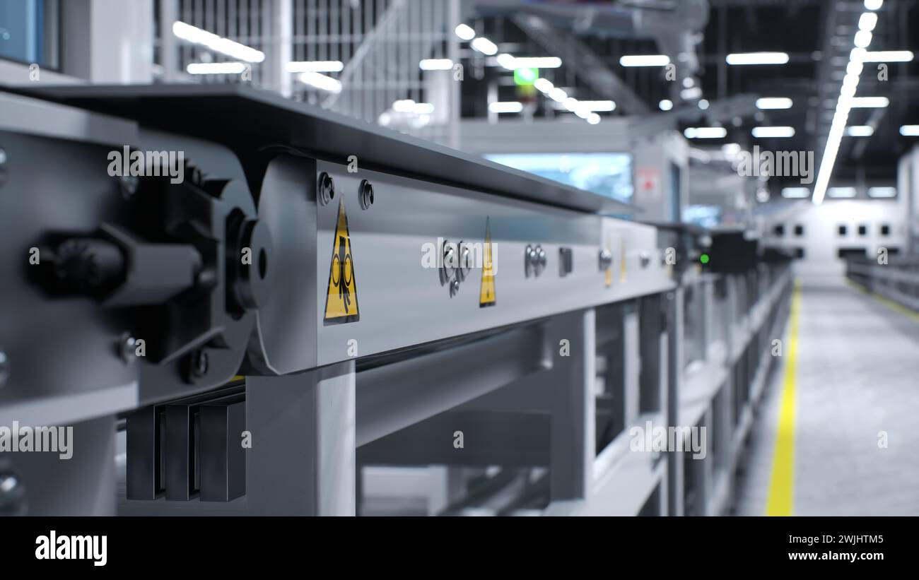 High voltage danger signs on conveyor belts in green technology factory ...