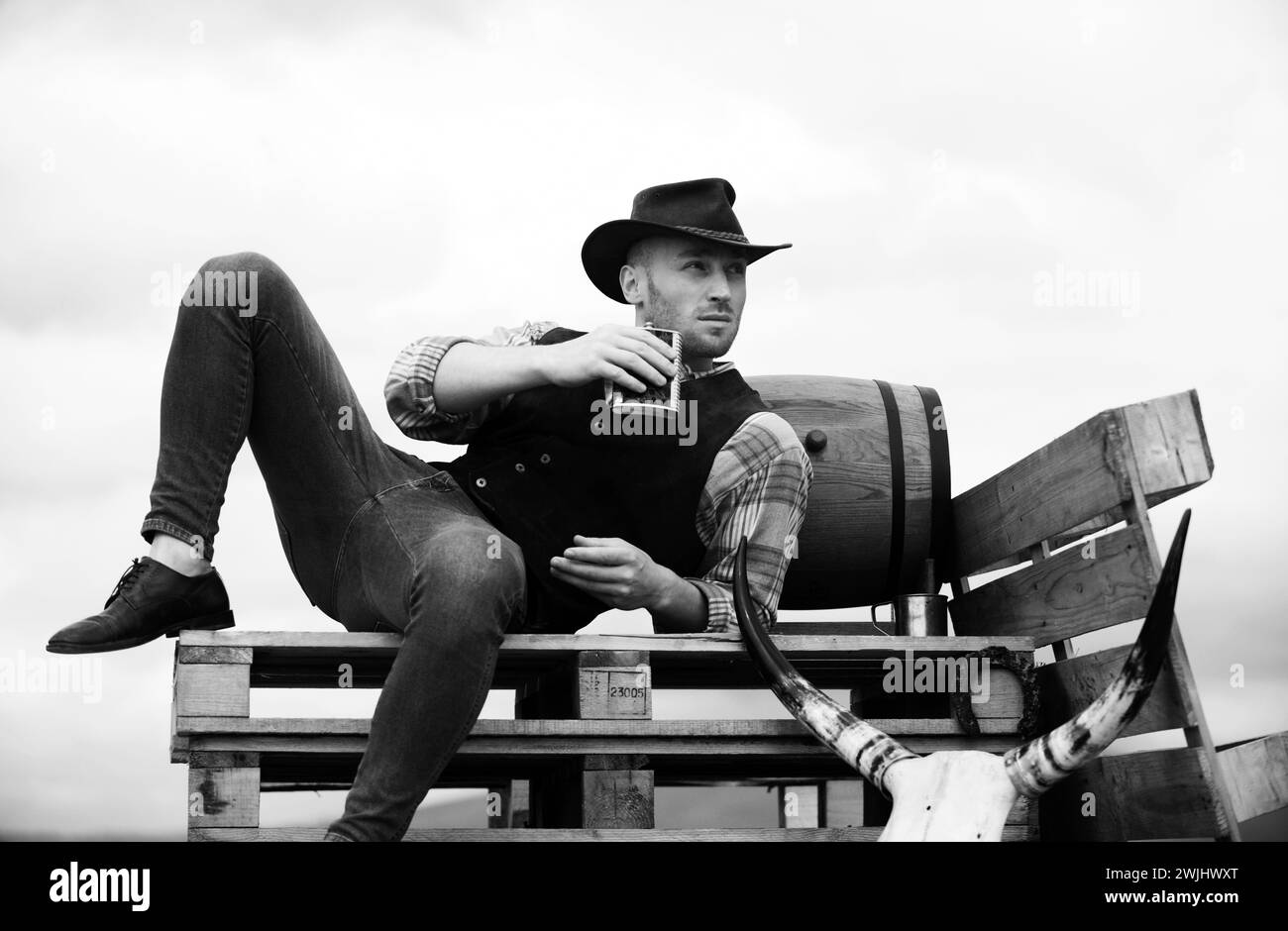 Cowboy on ranch. Handsome man in cowboy hat and retro vintage outfit ...