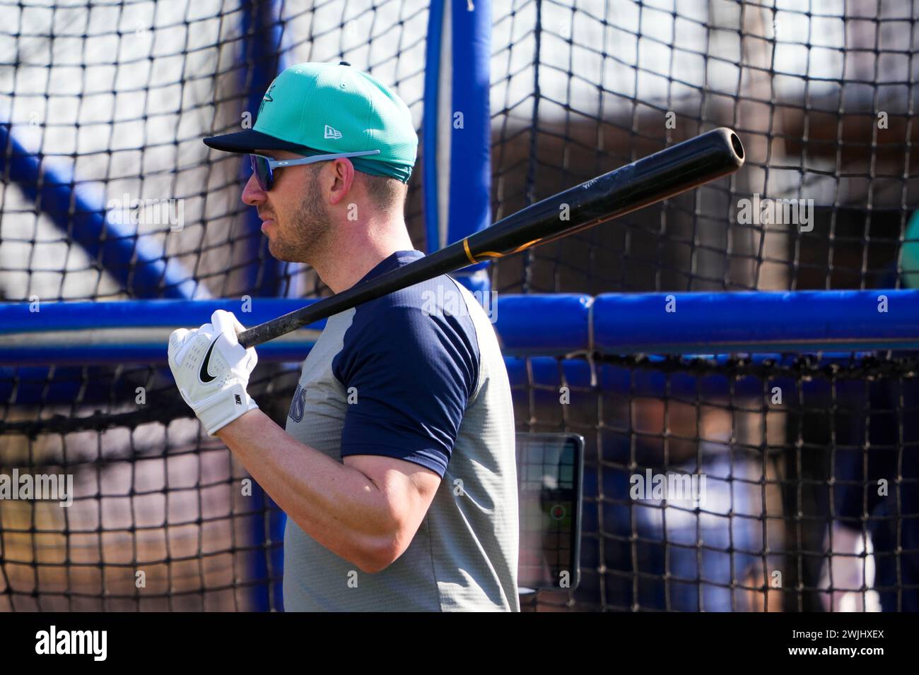 Seattle Mariners' Mitch Garver holds a bat after taking a short batting ...