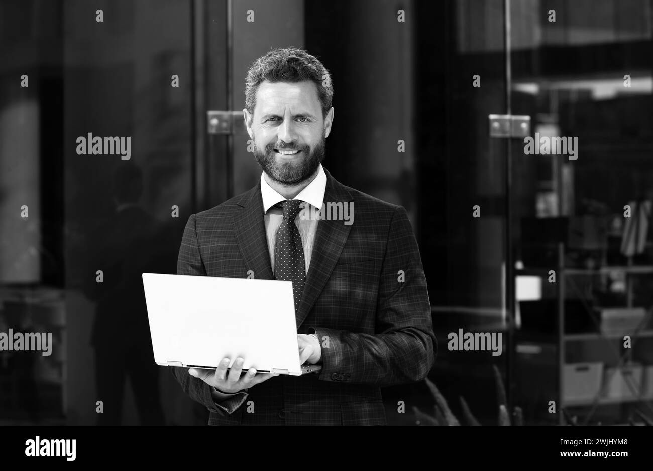 Businessman using laptop outdoor Black and White Stock Photos & Images ...