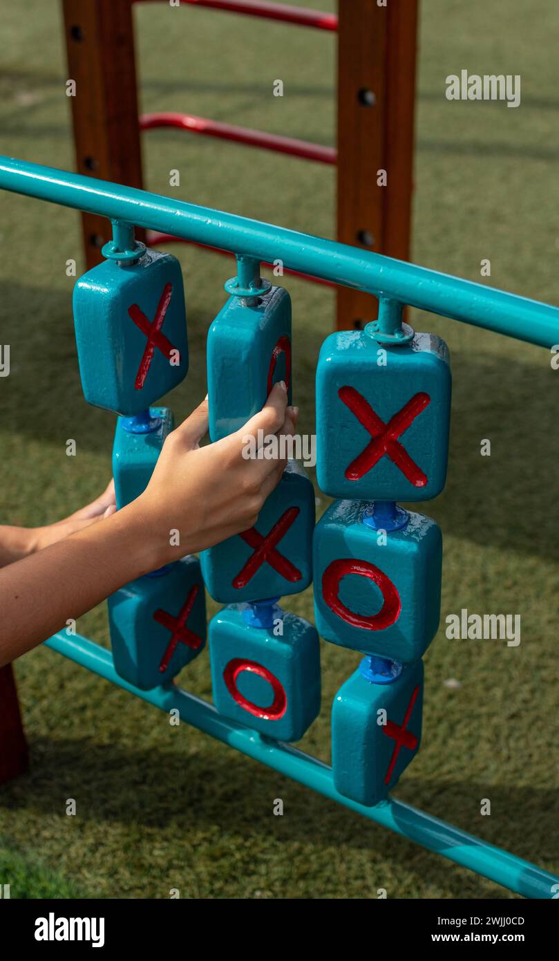 Girl playing tic tac toe in a playground Stock Photo - Alamy
