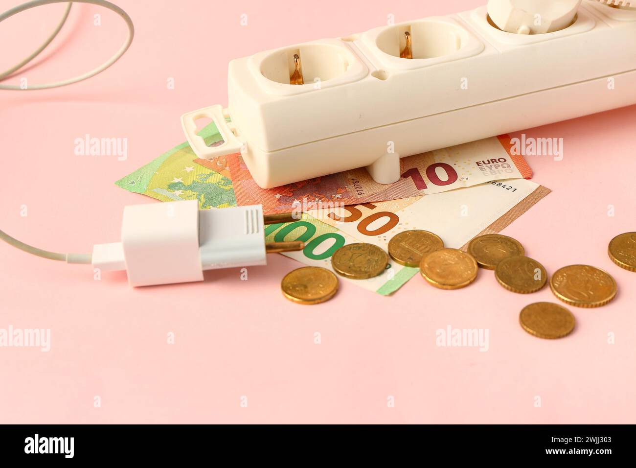 Power socket with money and plugs on pink background. Electricity bill ...