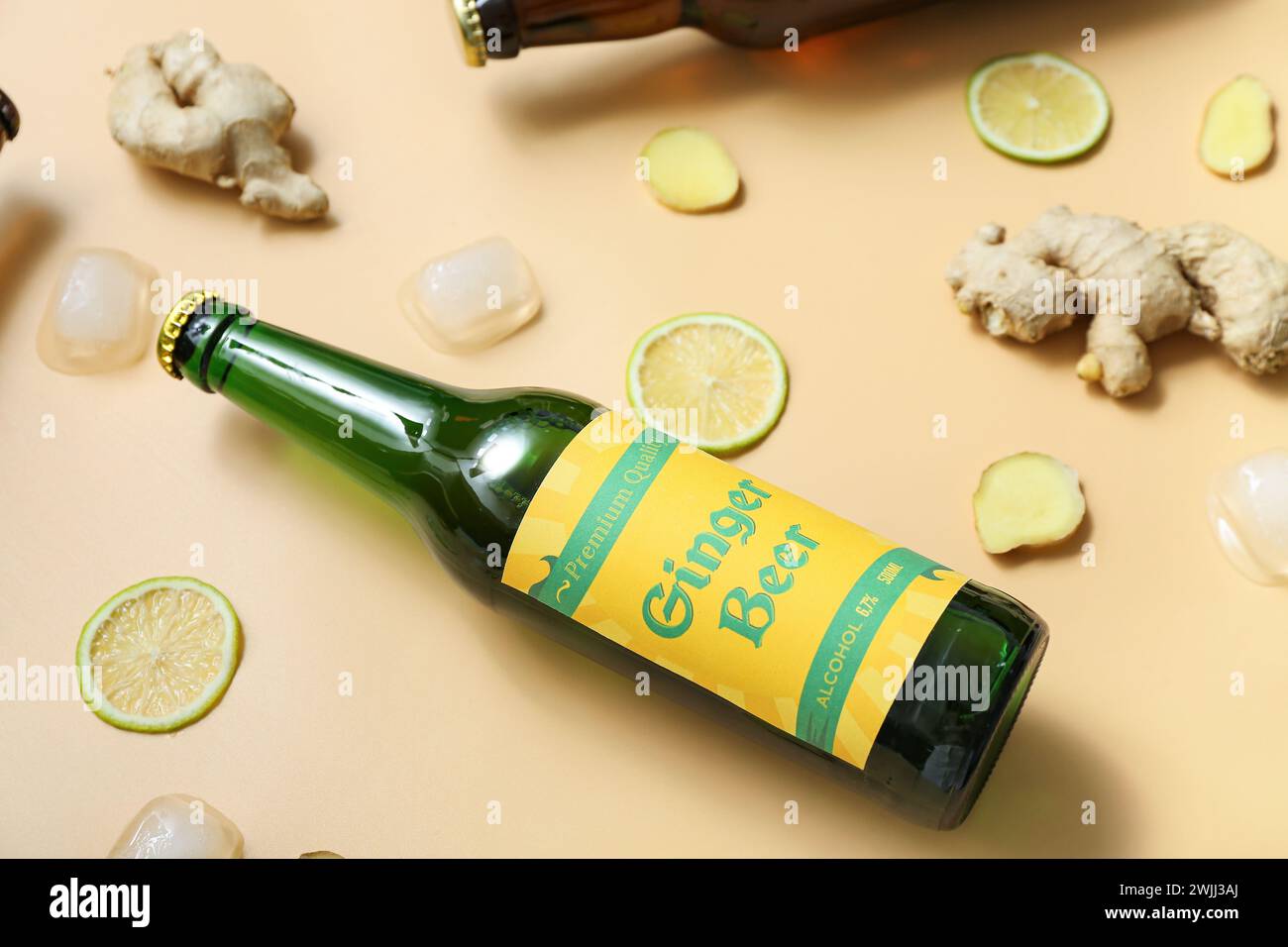 Composition with bottle of fresh ginger beer, lime slices and ice cubes ...