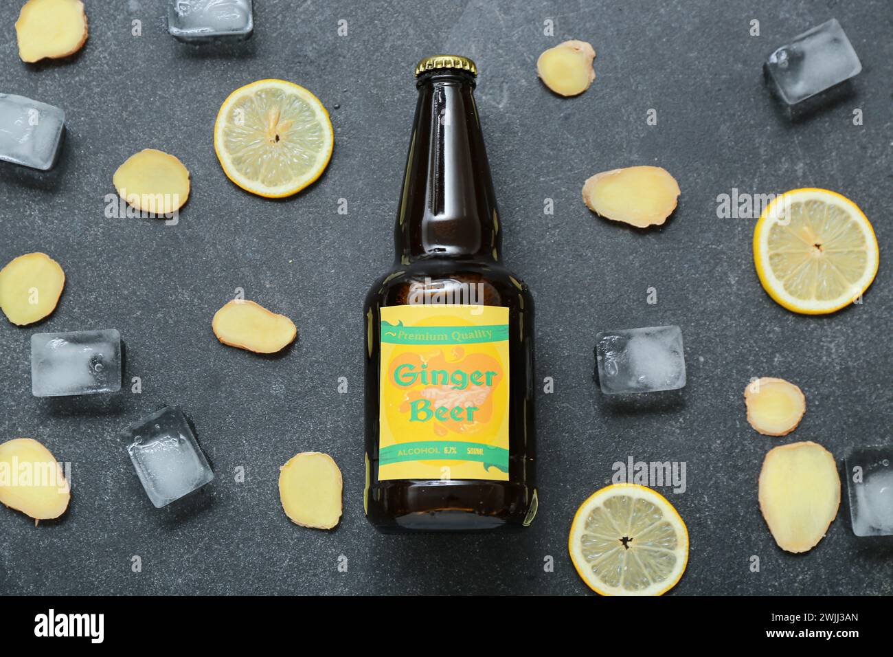 Composition with bottle of fresh ginger beer, lemon slices and ice ...