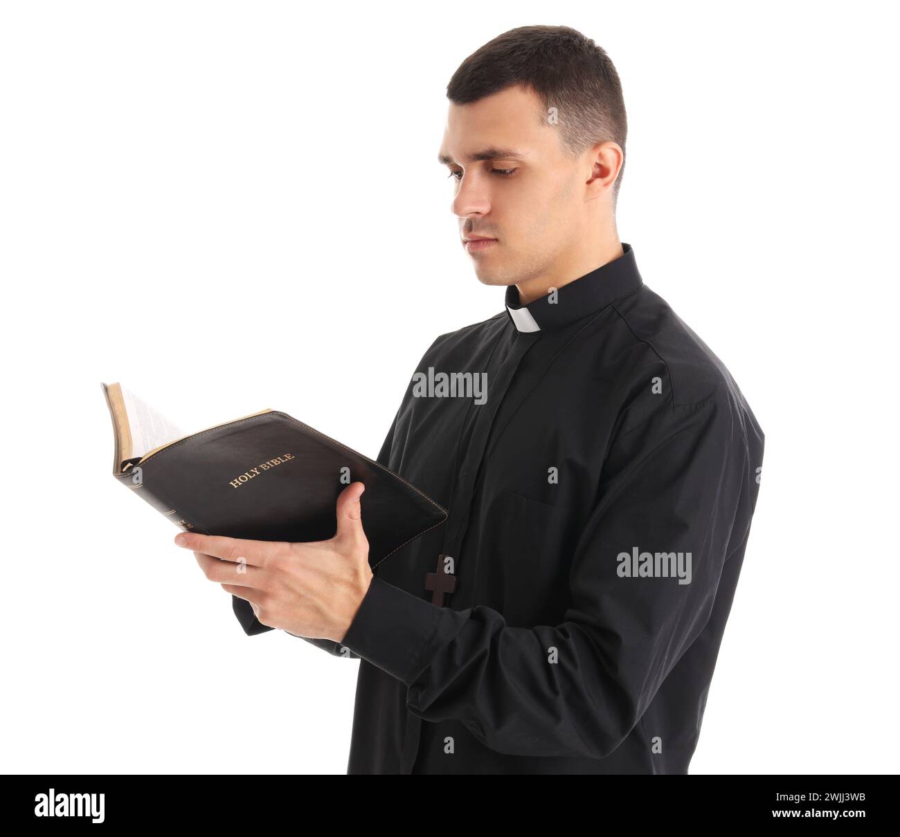 Young priest reading Holy Bible on white background Stock Photo - Alamy