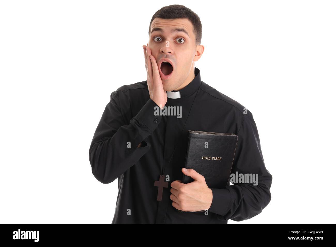 Shocked young priest with Holy Bible on white background Stock Photo ...