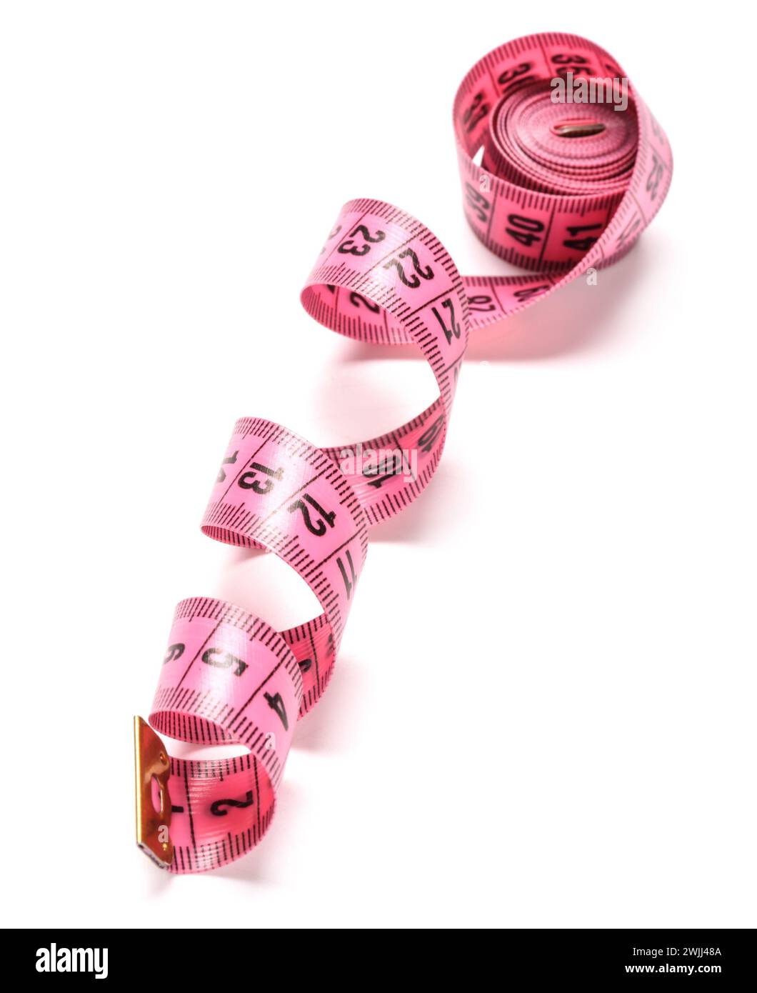 Pink measuring tape on white background Stock Photo - Alamy