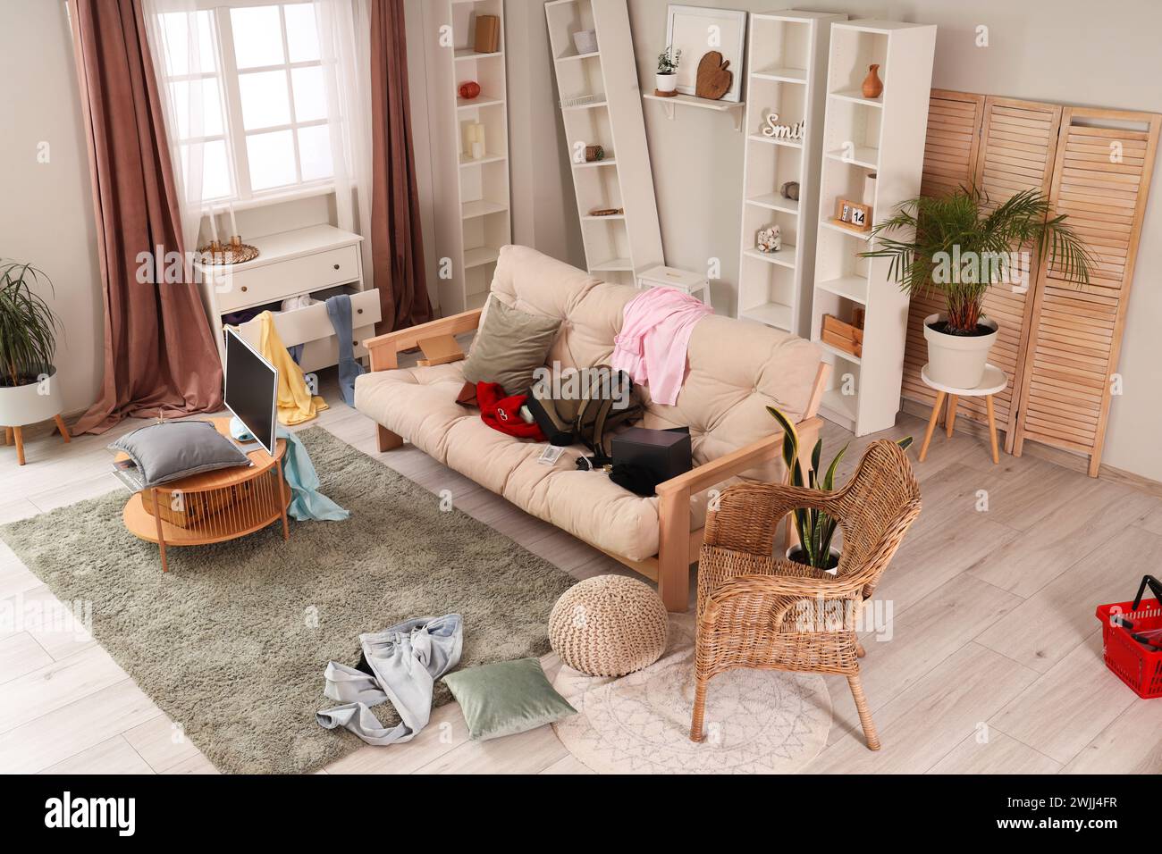 Interior of messy living room with sofa after robbery Stock Photo - Alamy
