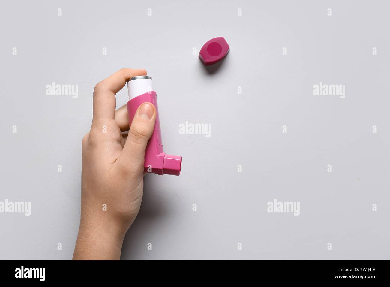 Child's hand with asthma inhaler on white background Stock Photo - Alamy