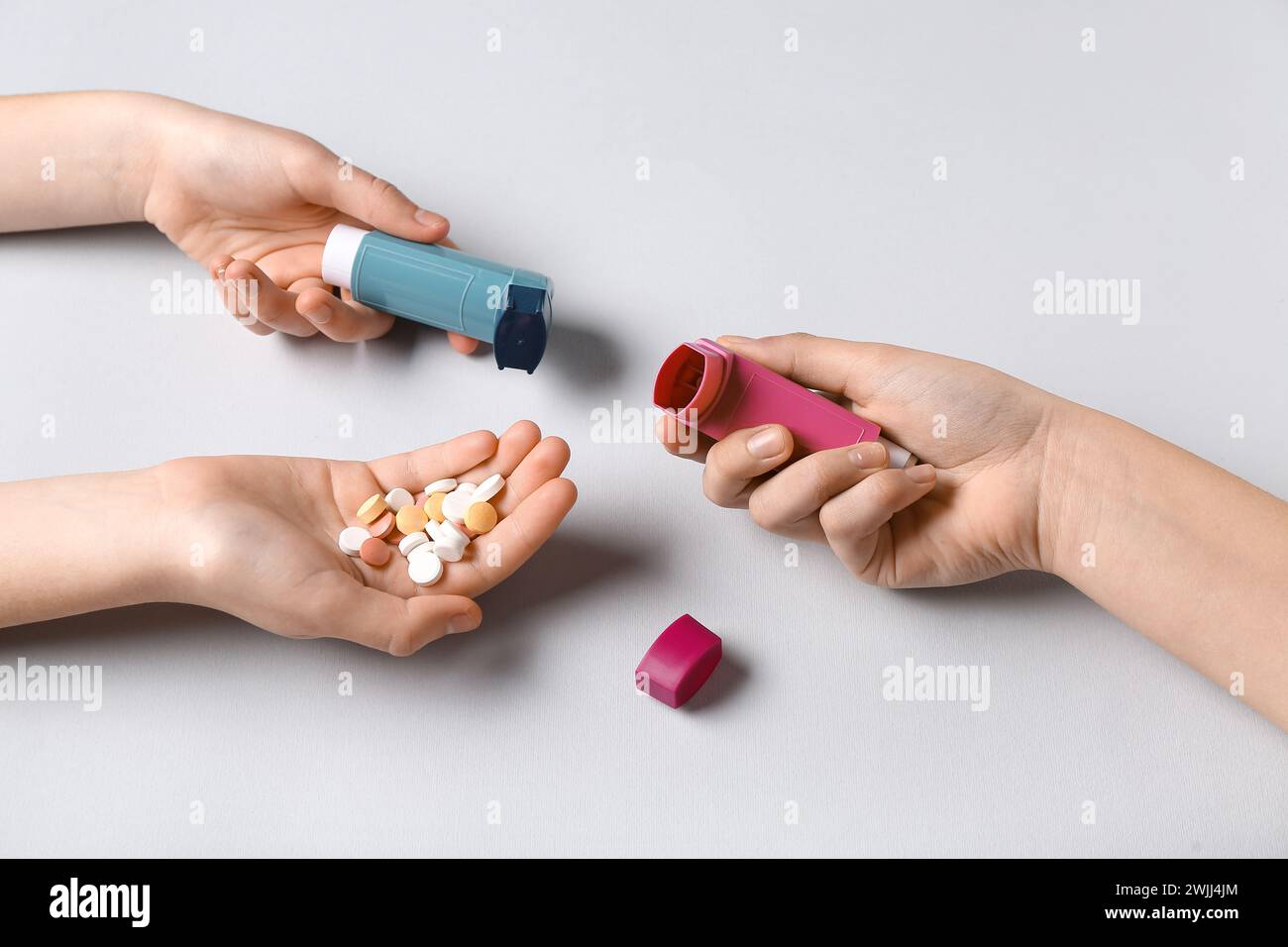 Child's hands with asthma inhalers and pills on white background Stock ...