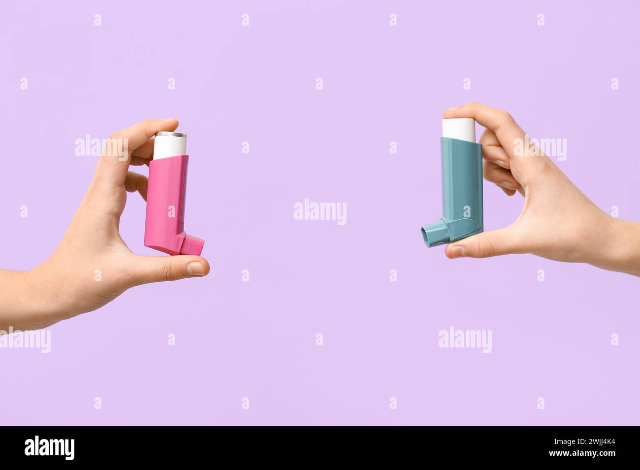 Child's hands with asthma inhalers on lilac background Stock Photo - Alamy