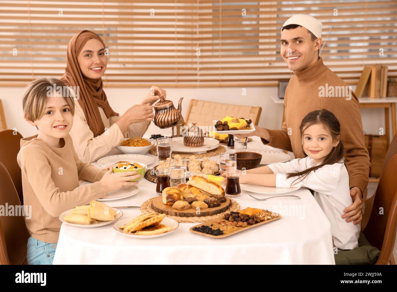 Muslim family having dinner at home. Ramadan celebration Stock Photo ...