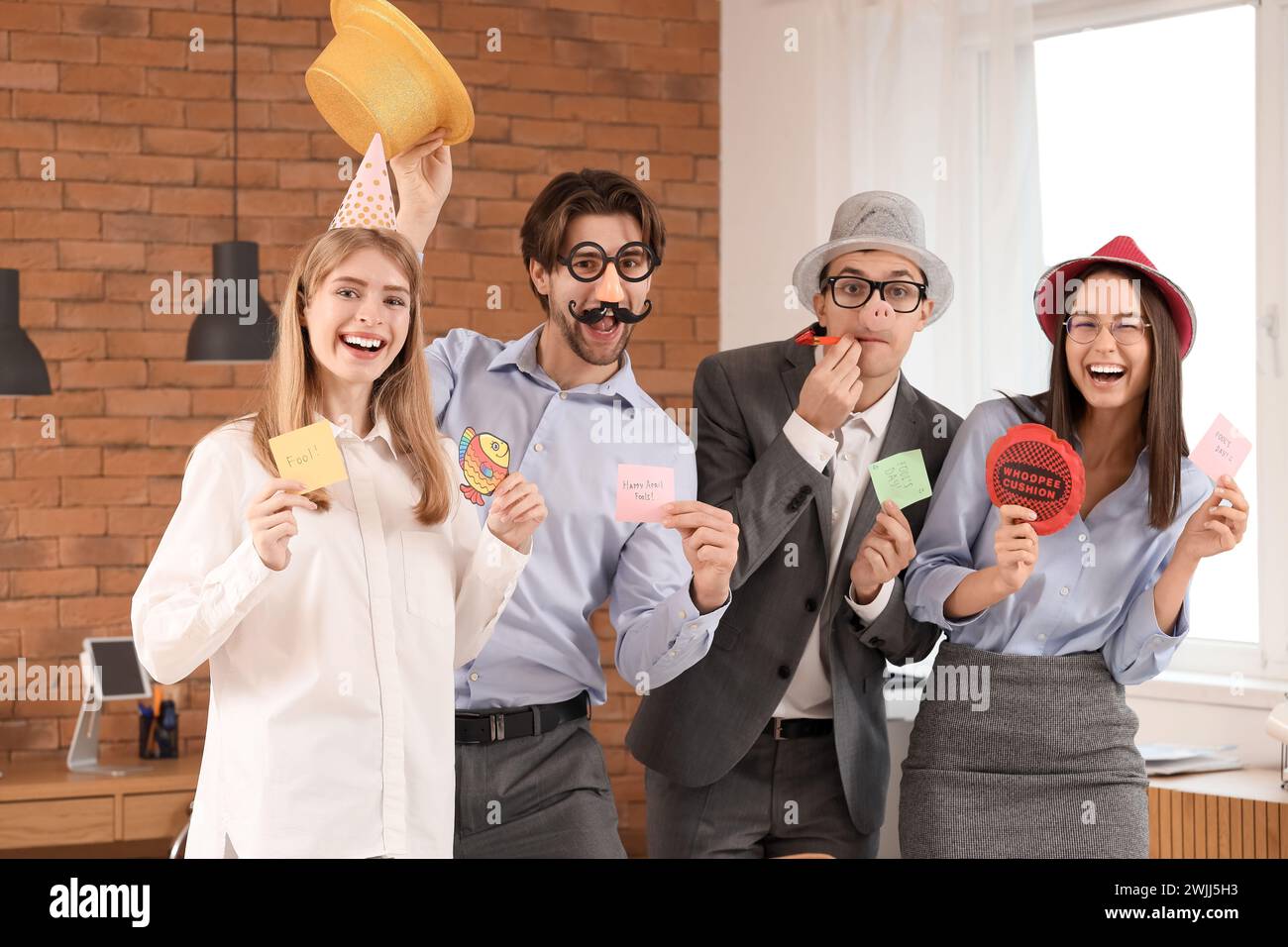 Business colleagues with funny disguise and sticky papers in office ...
