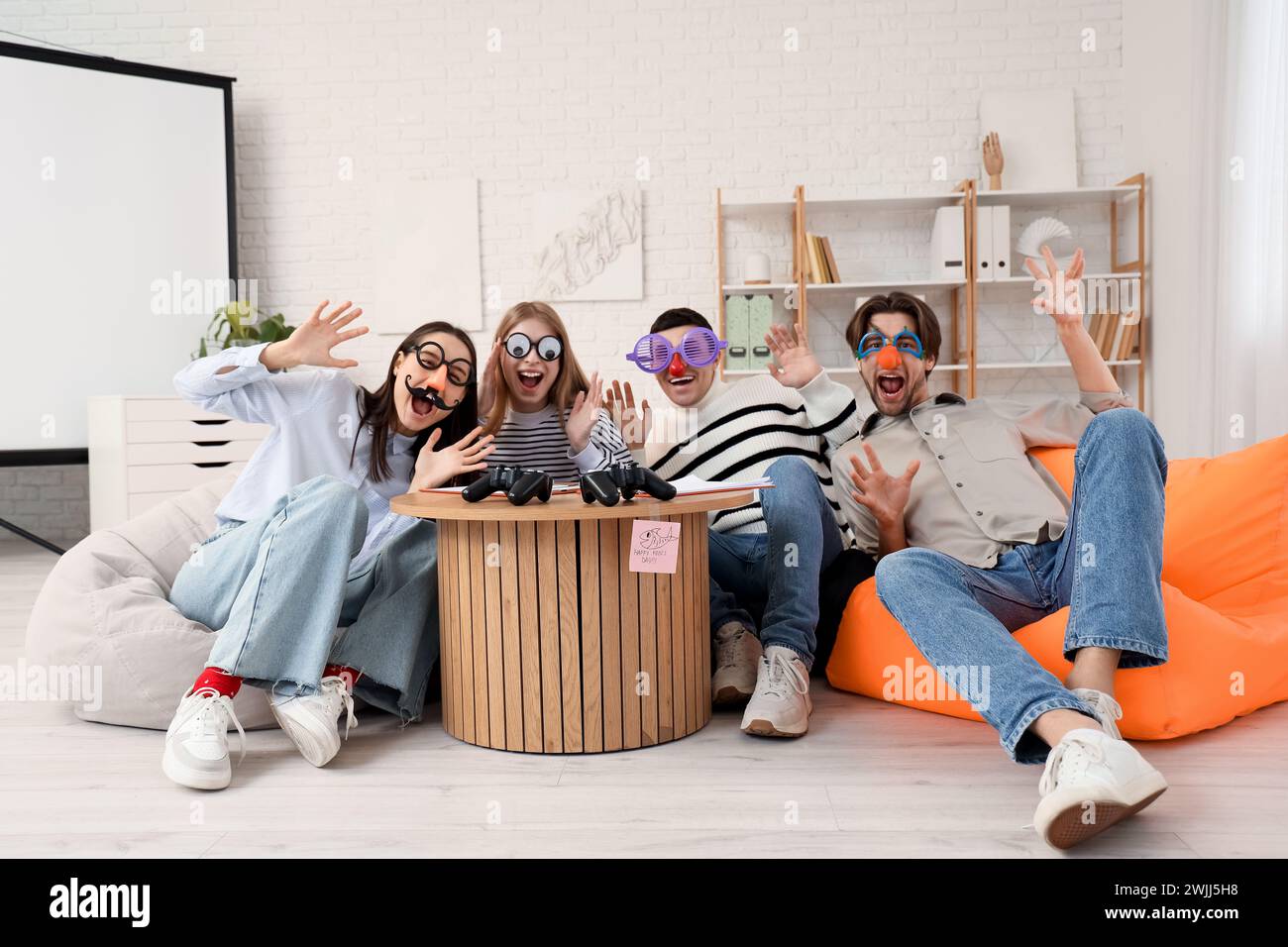 Happy business colleagues with funny disguise in office. April Fools ...