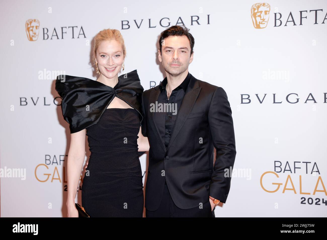 Caitlin Fitzgerald, left, and Aidan Turner pose for photographers upon ...
