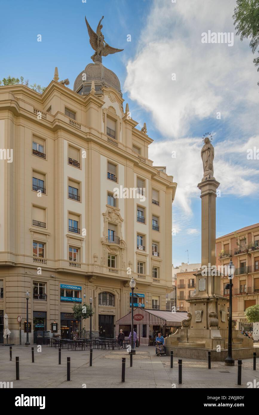 The statue of the Virgin Mary and the building of La Unión y el Fénix in the Plaza de Santa ...